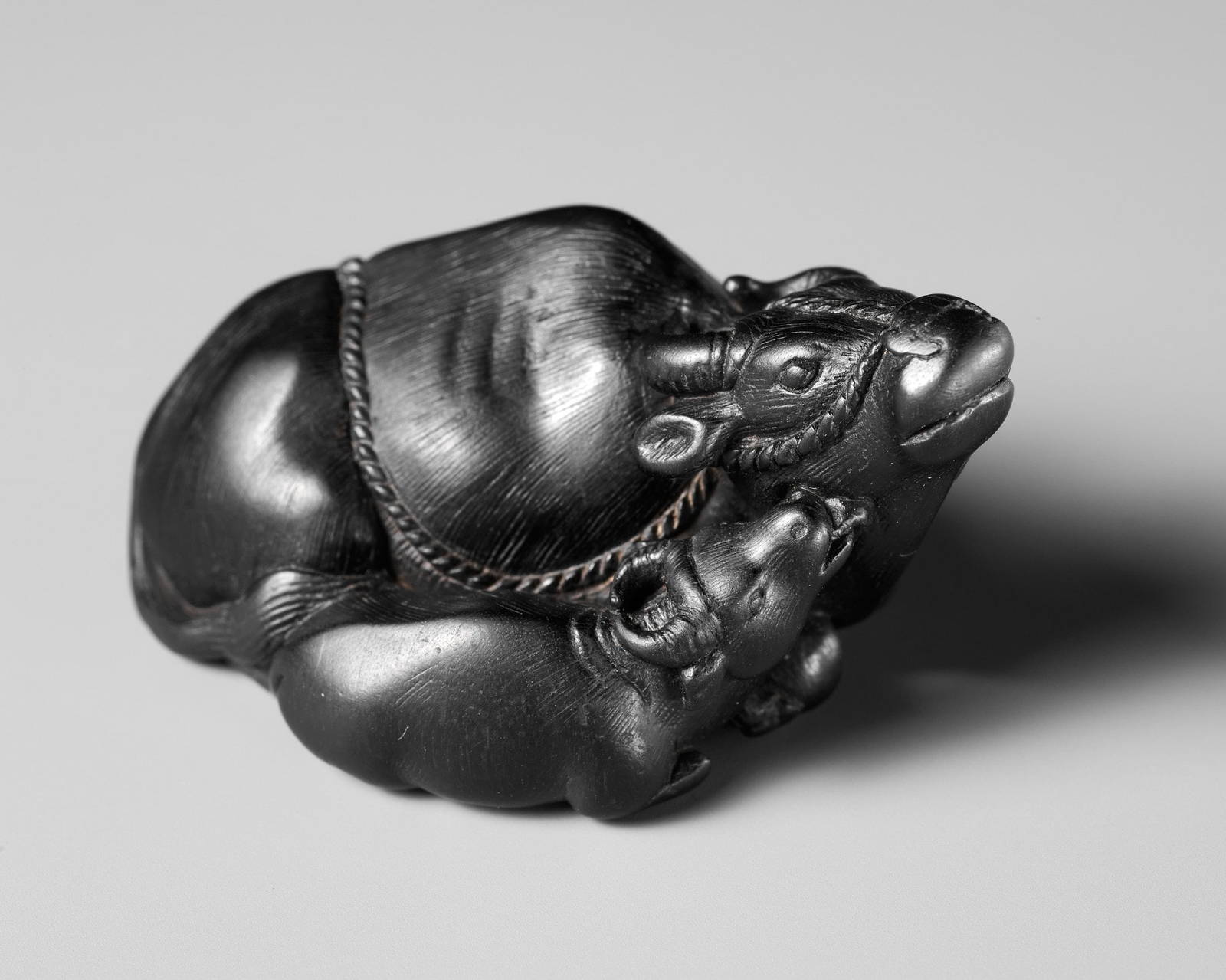 A Fine Ebony Wood Netsuke Of A Recumbent Cow With Calf Auction