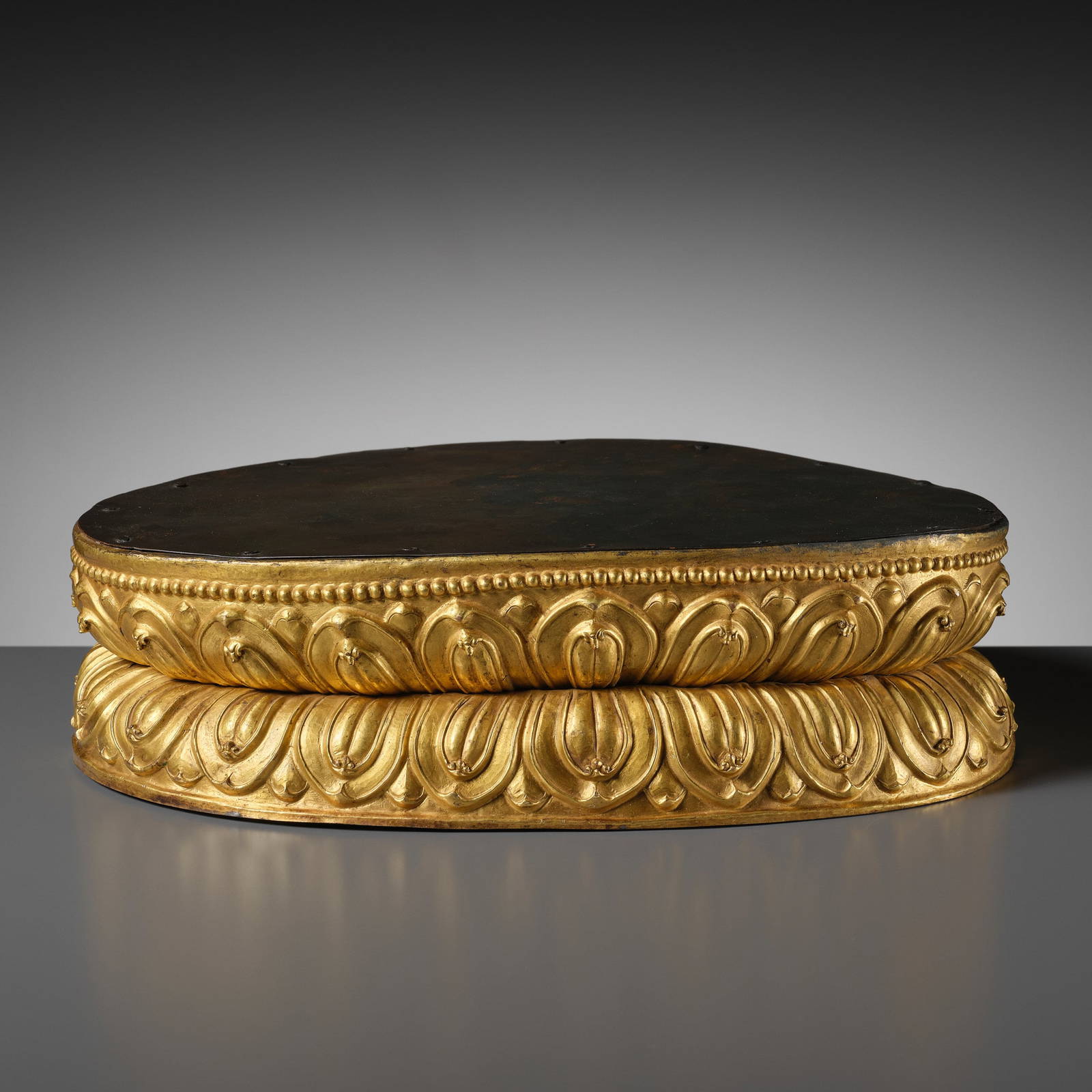 A Large And Gilt Copper Alloy Base, Tibet, 17th Century Auction
