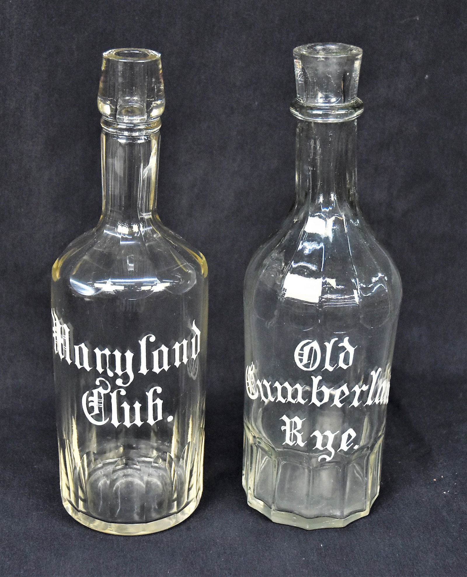 Two Enameled Whiskey Back Bar Bottles