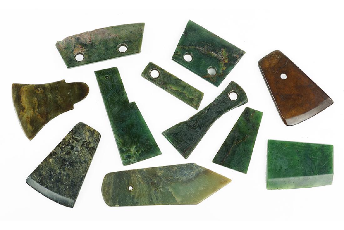 A Collection Of Carved Stone Axe Heads.