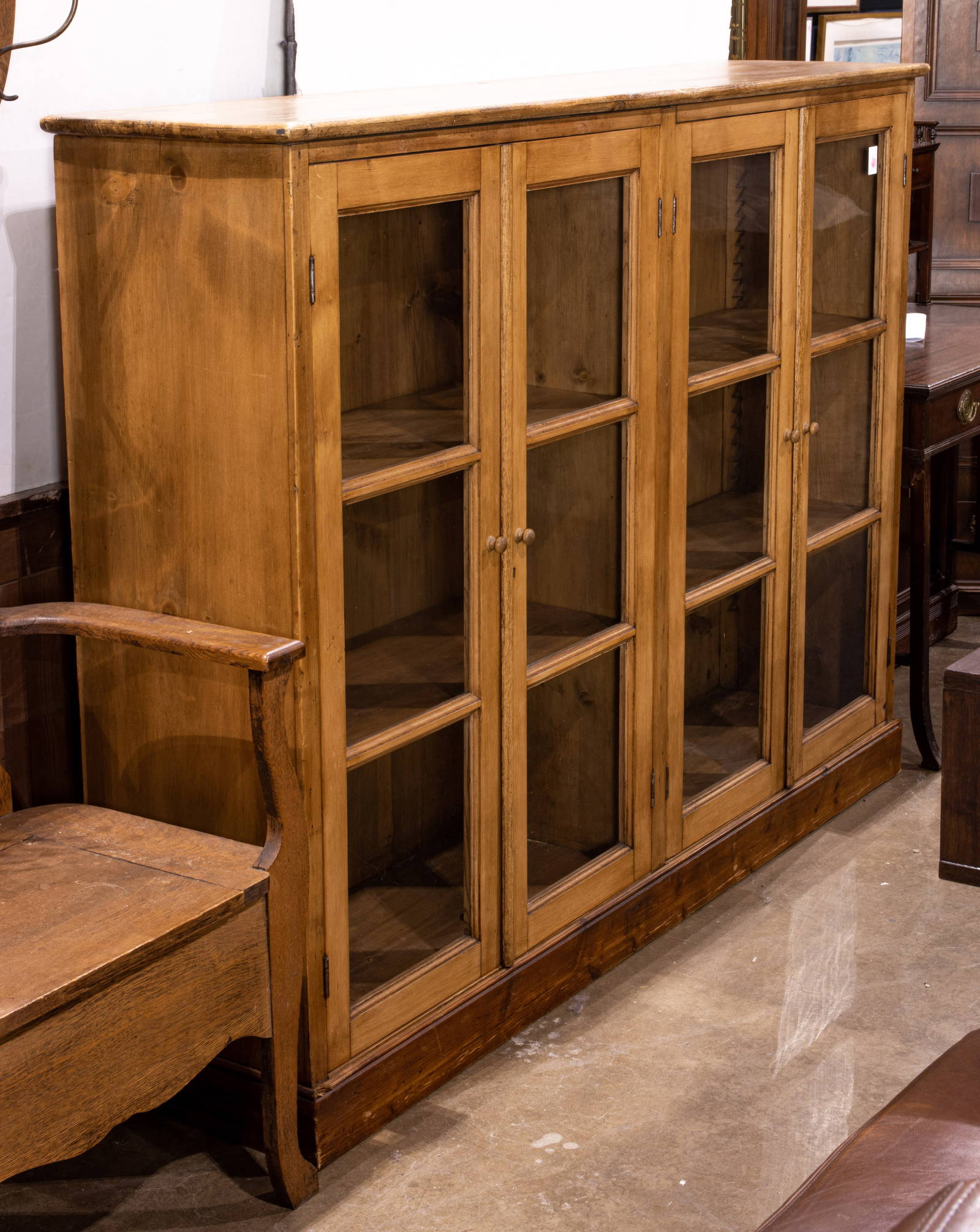 A Primitive Pine Case Bisectional Bookcase Fitted With Four Glazed ...