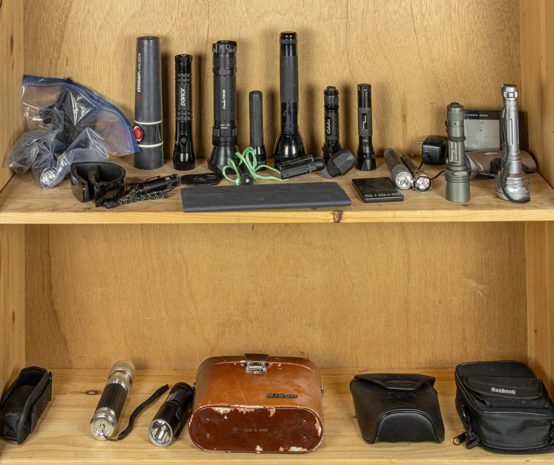 Two Shelves Of Handheld Flashlights And Cases Auction
