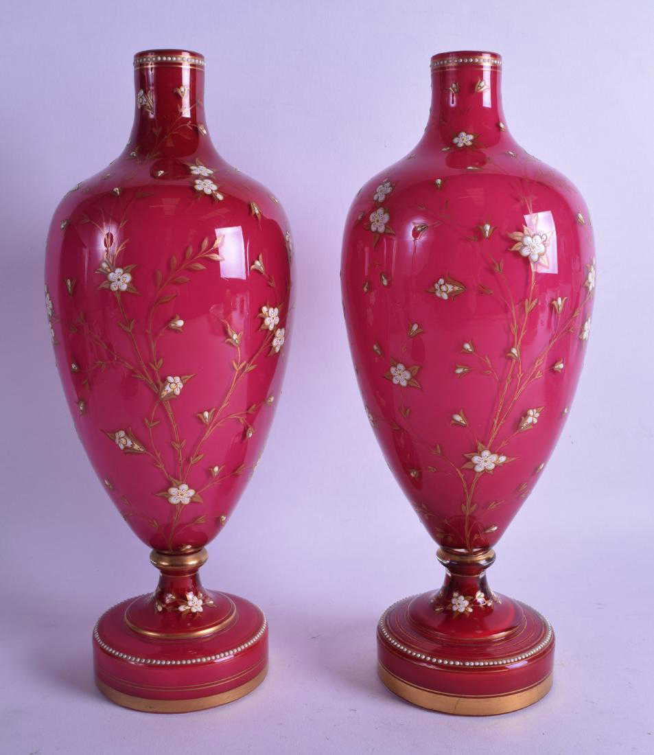 A PAIR OF VICTORIAN ENAMELLED PINK GLASS VASES painted A PAIR OF VICTORIAN ENAMELLED PINK GLASS VASES painted