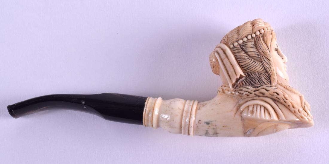 A NOVELTY CARVED BONE PIPE. 15 cm long.