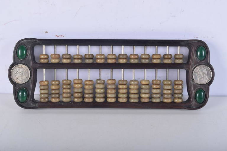 A Chinese hard stone abacus within a hardwood frame 14 x 42cm . (#3423 ...