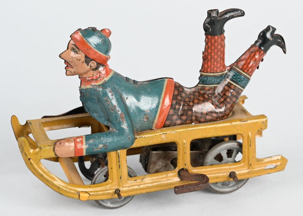 German Tin Windup Boy On Sled
