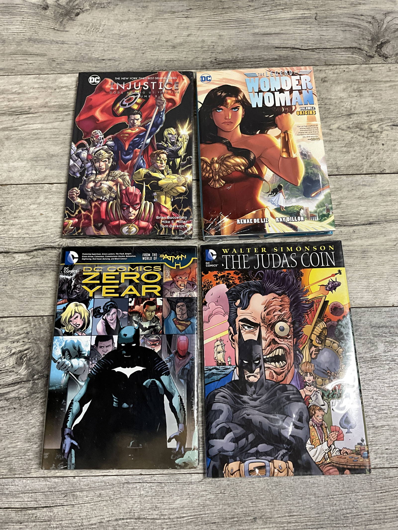 Four Assorted Dc Comic Hardcover Books. New- Still In Wrapper. Auction