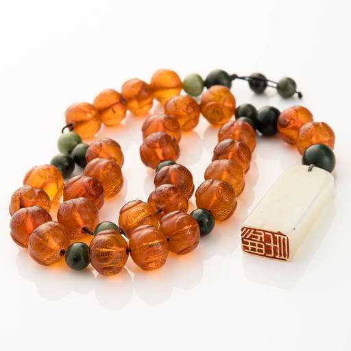 A Chinese amber necklace with a jade seal, 19th century (#0406) on Dec ...