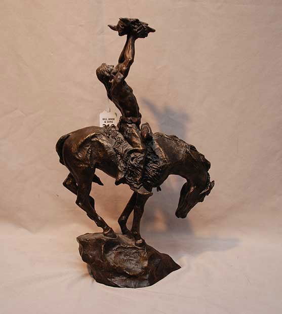 312: Bronze Indian on horseback holding buffalo skull a : Lot 312