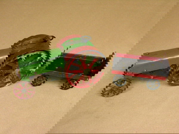 50: VINTAGE STRUCTO WIND-UP TRACTOR AND TRAILER