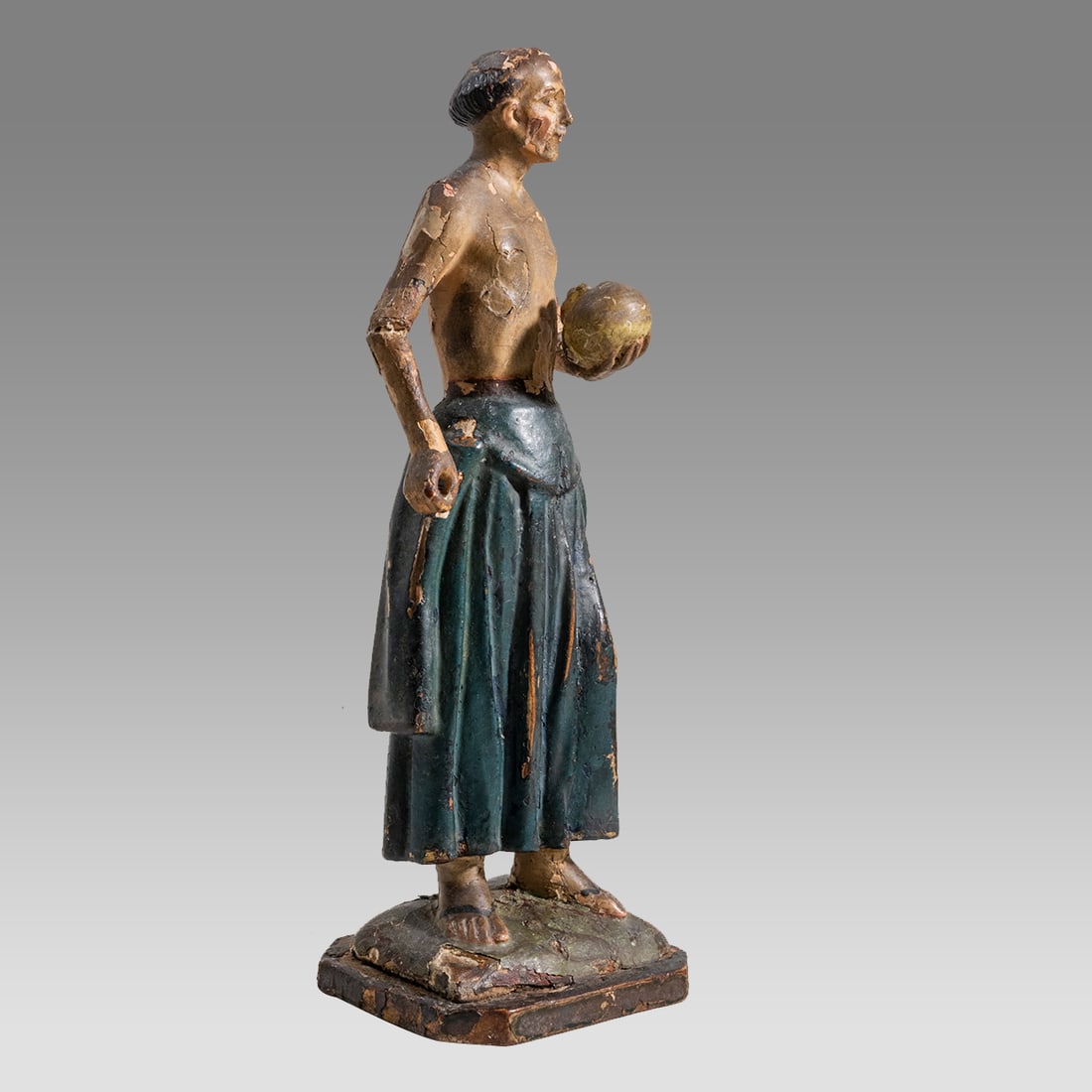 Spanish Colonial Polychrome Wood Saint Holding Skull. Auction