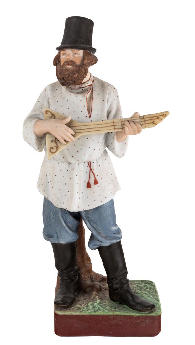 A RUSSIAN PORCELAIN FIGURE OF A BALALAIKA PLAYER,