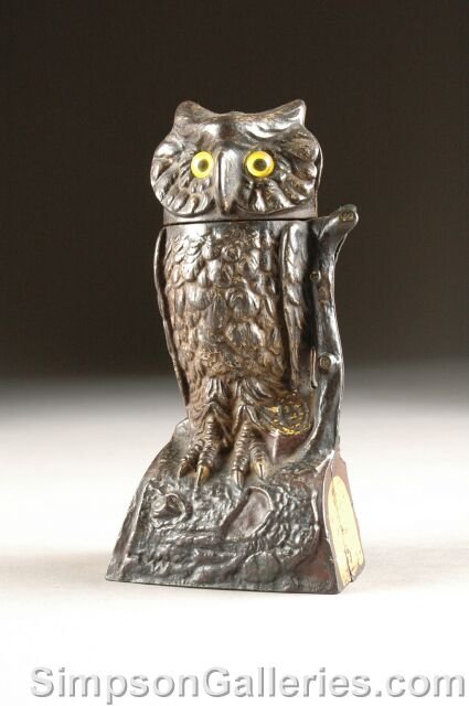 6: AN ANTIQUE AMERICAN CAST-IRON OWL MECHANICAL BANK by
