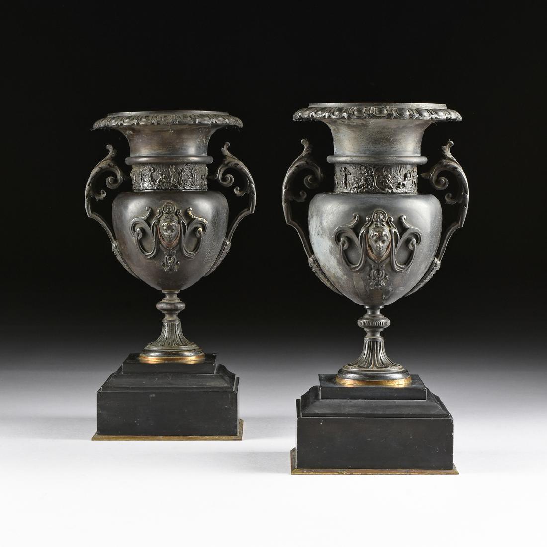 A PAIR OF BALDUC FRERES PATINATED METAL URNS ON BLACK