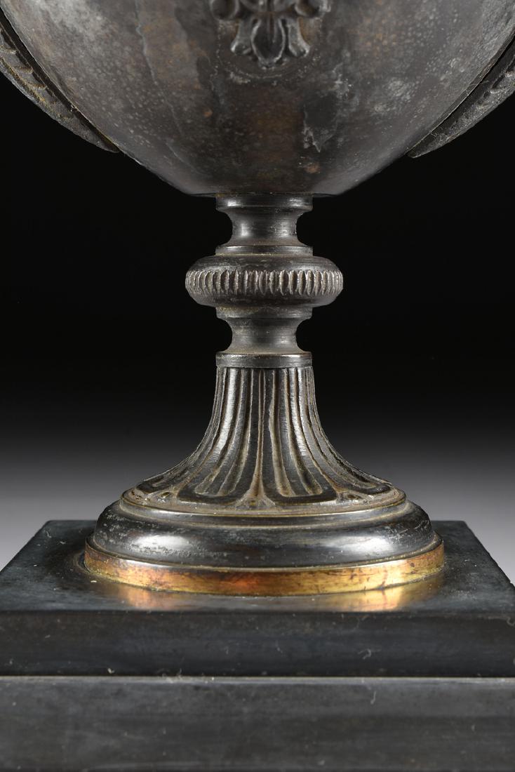 A PAIR OF BALDUC FRERES PATINATED METAL URNS ON BLACK