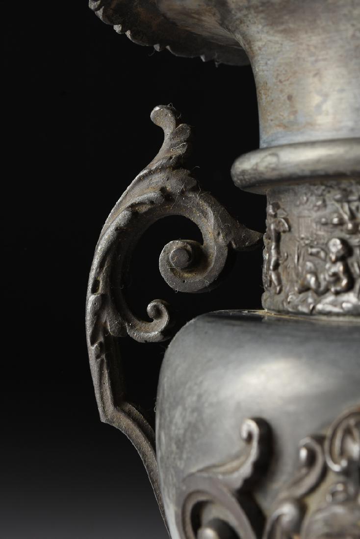 A PAIR OF BALDUC FRERES PATINATED METAL URNS ON BLACK