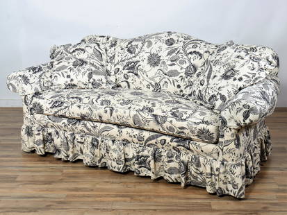 A Custom Camel Back Roll Arm Sofa