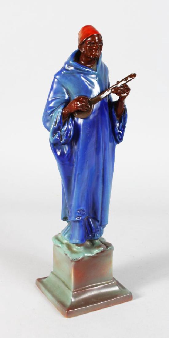 A ROYAL DOULTON FIGURE OF A MOORISH MINSTREL, designed