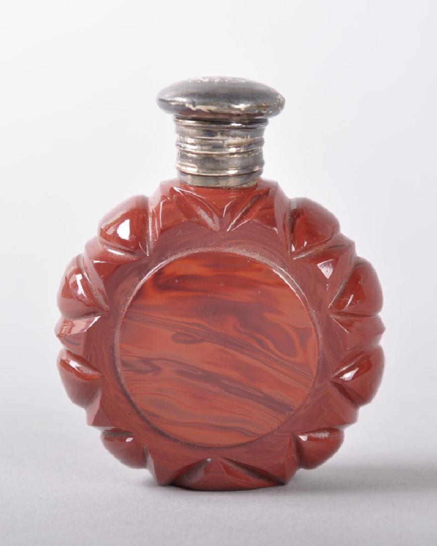 A CUT AND POLISHED RED AGATE PERFUME BOTTLE with silver