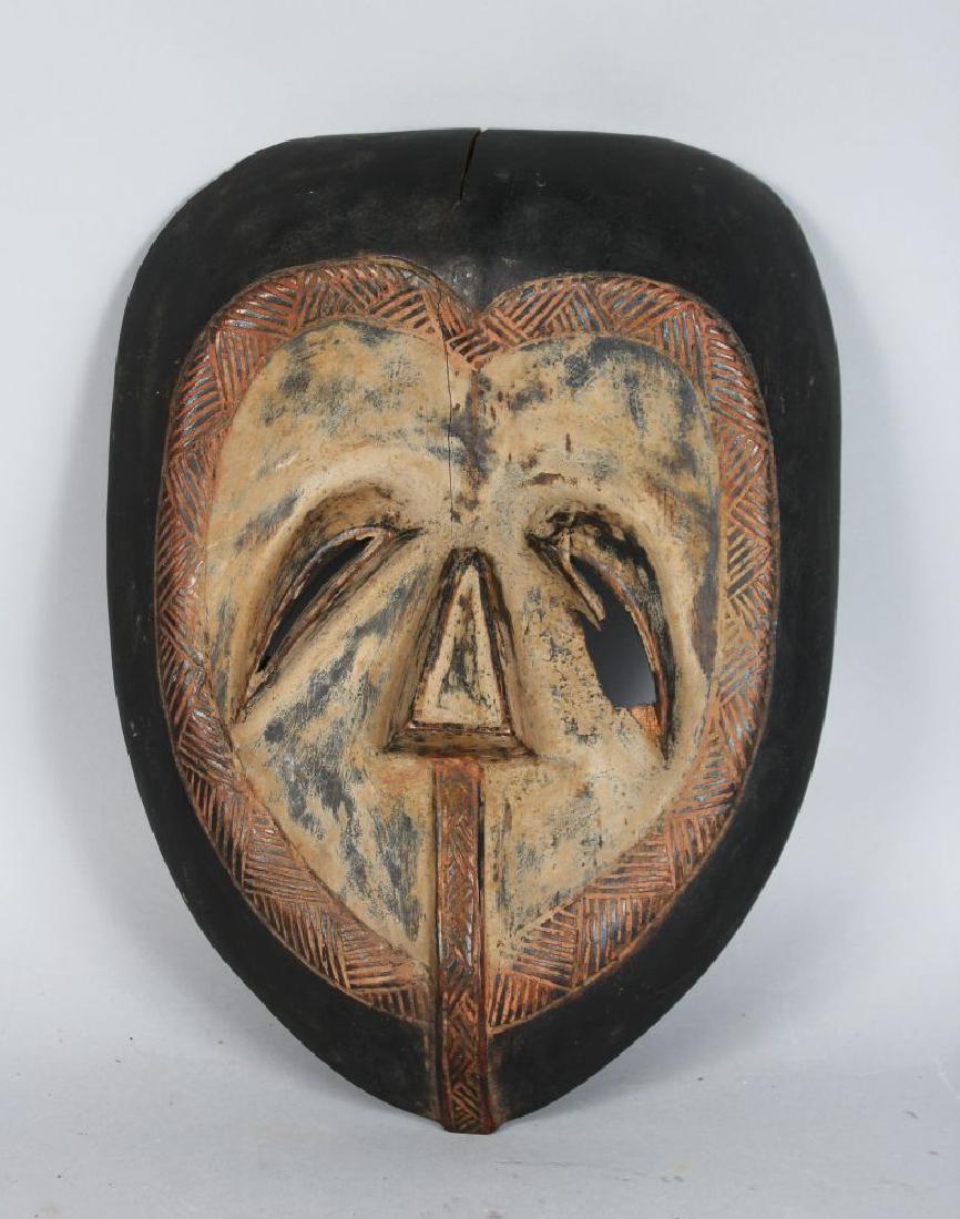 AN AFRICAN CARVED WOOD MASK, TSOGO STYLE, pierced eyes,