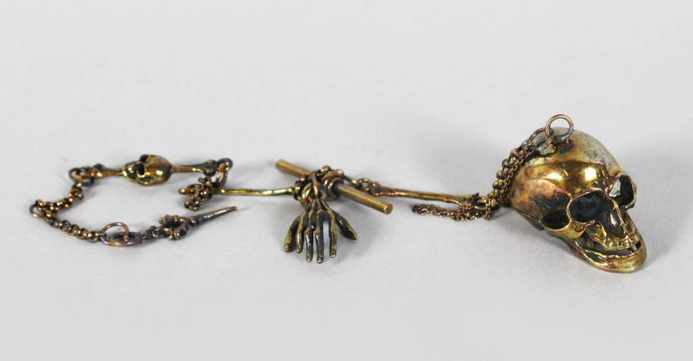 A Brass Skull Shape Snuff Box And Chain. 1.5ins Long.