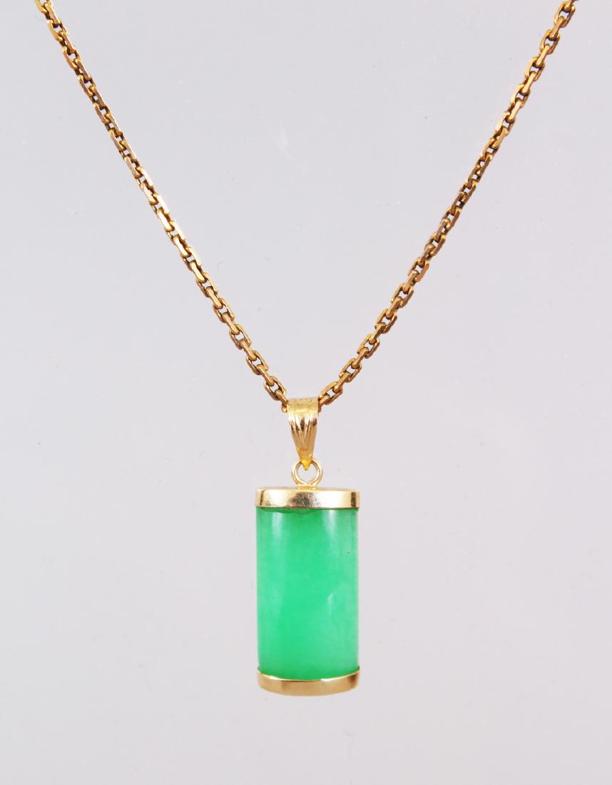 A GOLD CHAIN with jade pendant.