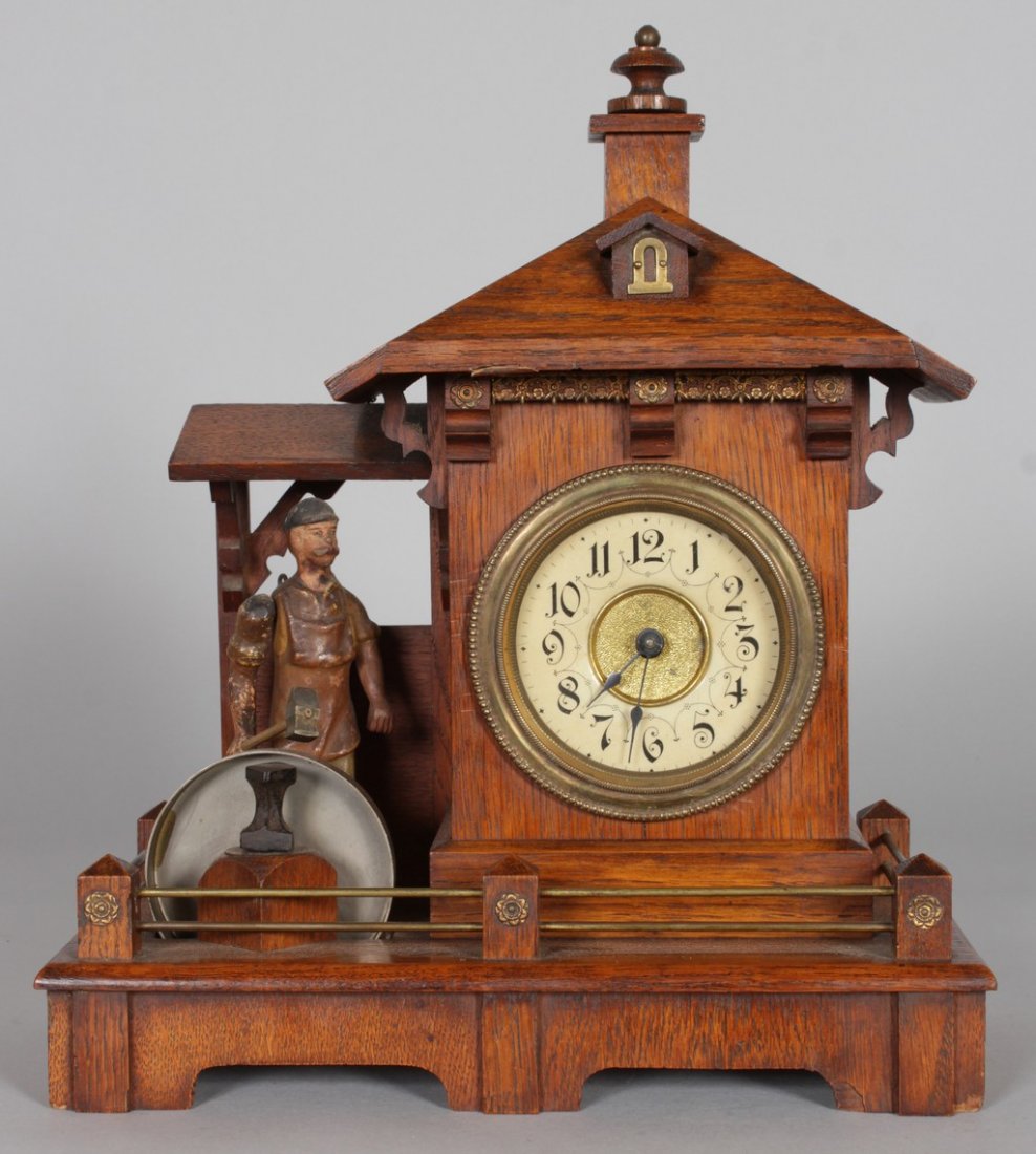 A 19TH CENTURY OAK AUTOMATON CLOCK, modelled as a