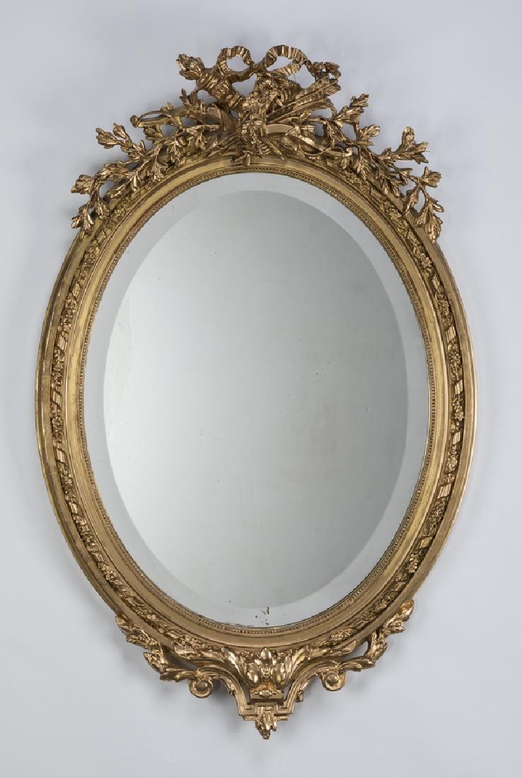 19th c. Rococo style oval gilt wood beveled mirror