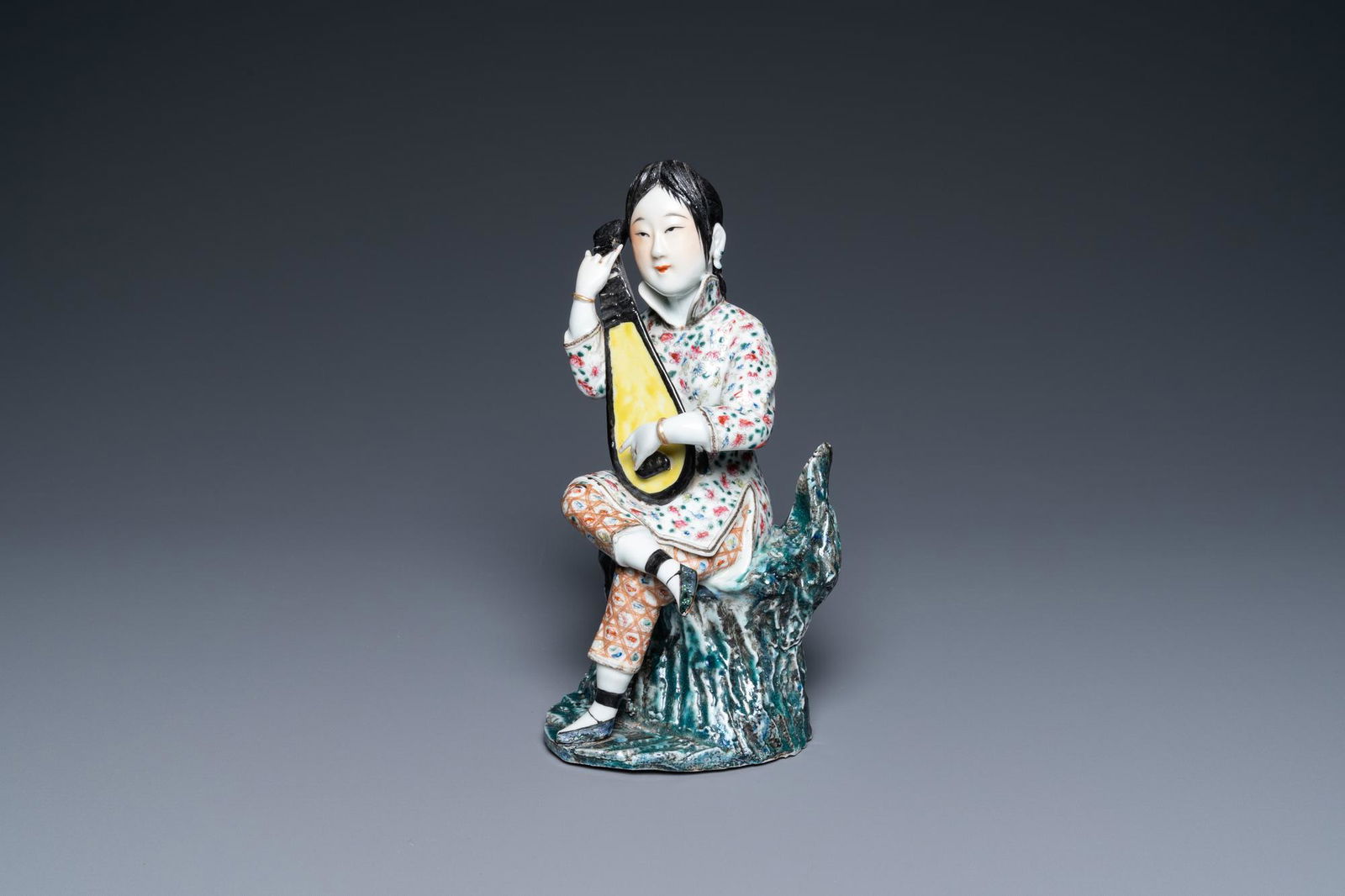 A Chinese famille rose figure of a musician, Fu Jian Hui Guan mark ...