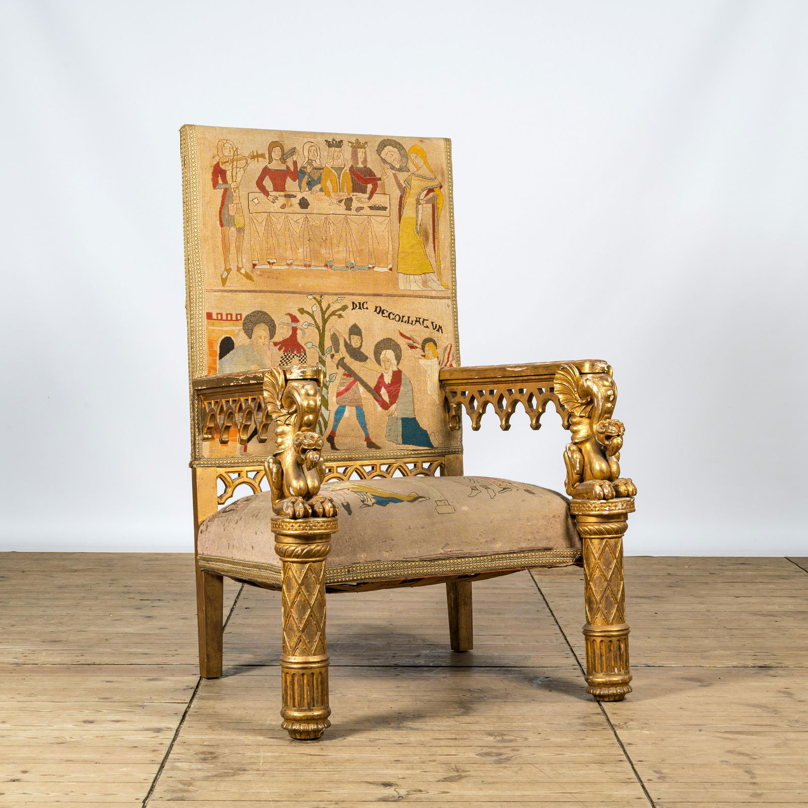 An imposing gilt wooden throne chair with griffins and woven seating in ...
