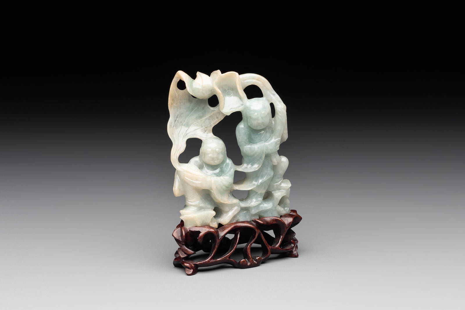 A Chinese Jade 'he He Er Xian' Group On Wooden Stand, 19th C. Auction