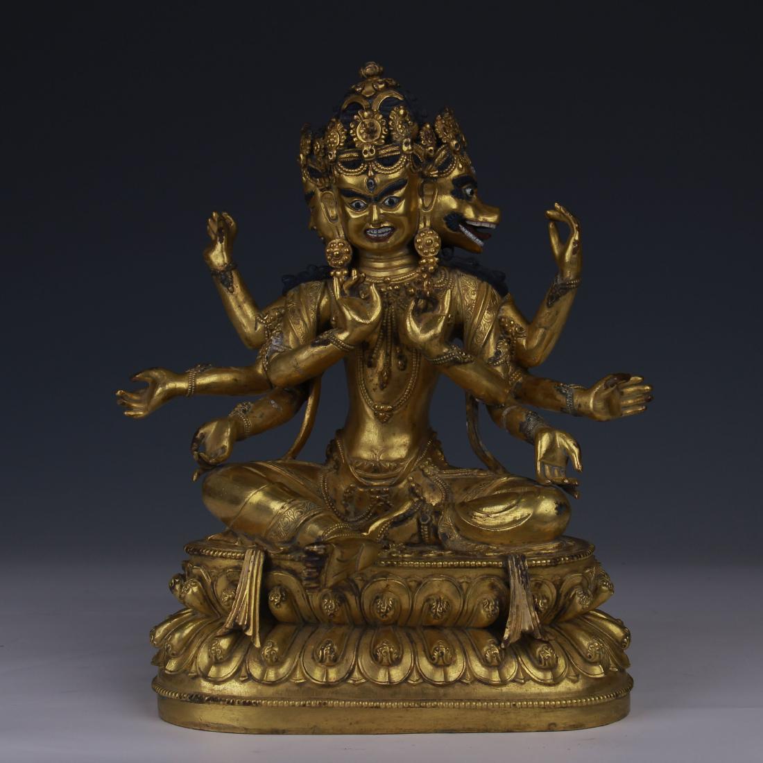 TIBETAN GILT BRONZE SEATED THREE FACE EIGHT ARM BUDDHA