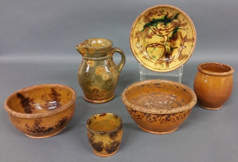 Six pieces of early redware including a bird pie plate