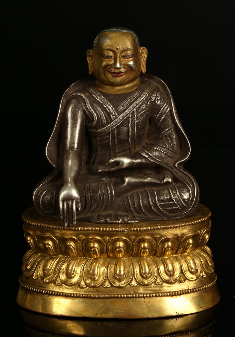 A CHINESE SILVER FIGURE OF A GURU