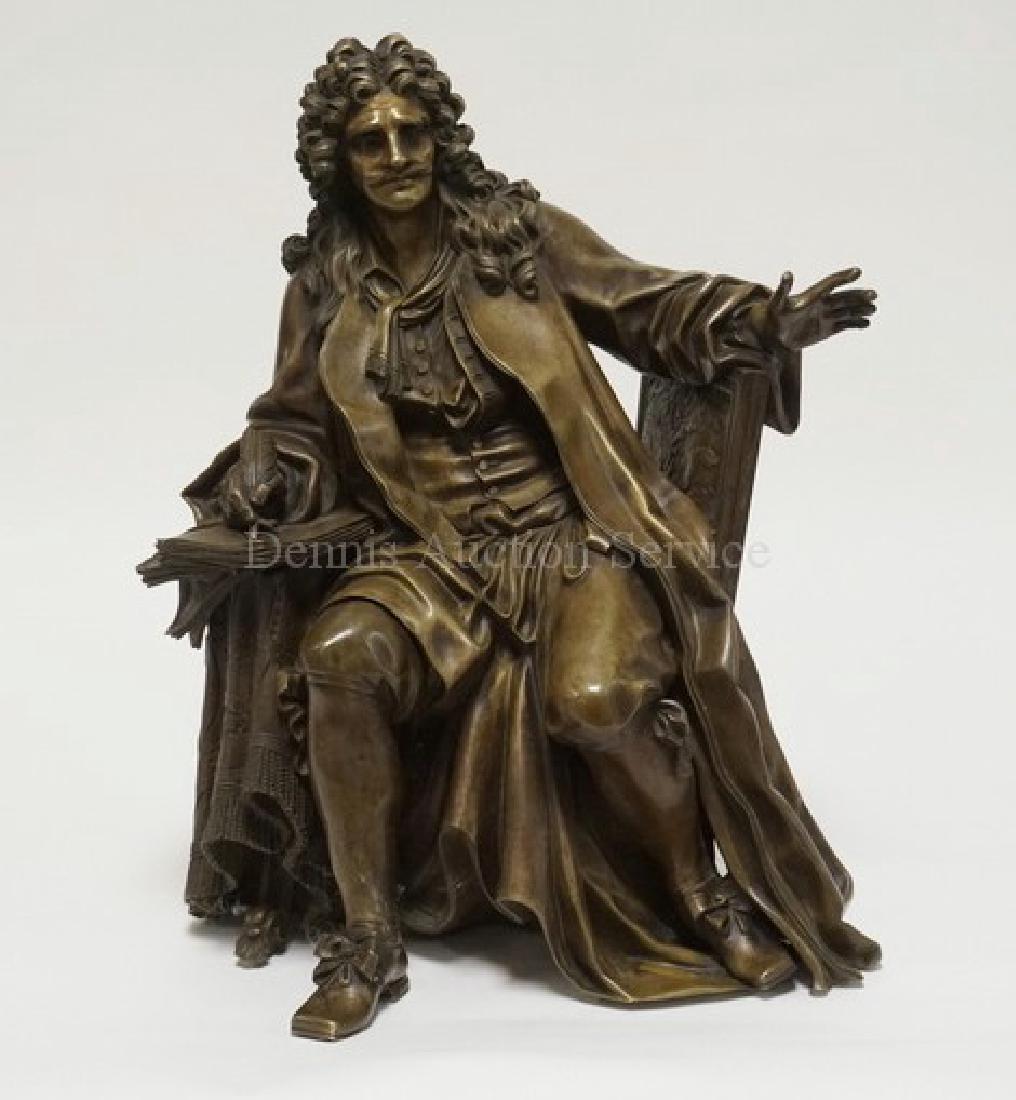 BRONZE SCULPTURE OF A SEATED MAN WRITING WITH QUILL