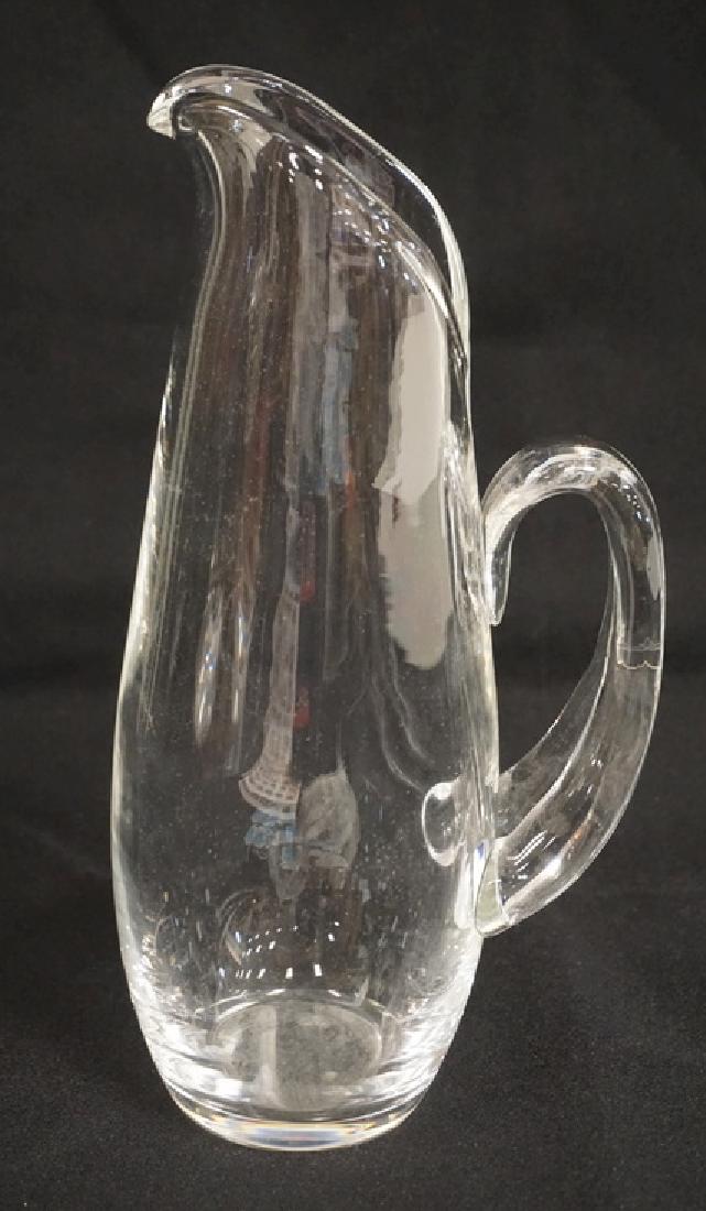 STEUBEN CRYSTAL PITCHER WITH AN APPLIED SPLIT HANDLE.