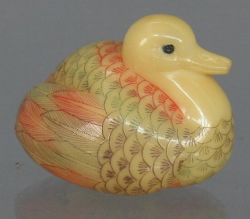 2604: DUCK NETSUKE. The bone netsuke has engraved feat