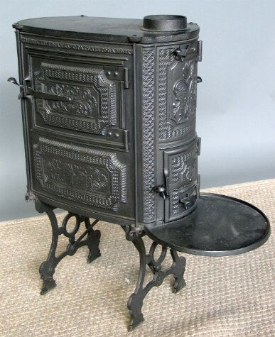 1042: ORNATE CAST IRON STOVE ON STAND. Reproduction, h