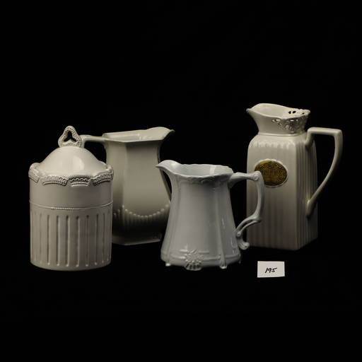 Three Water Pitchers And A Cookie Jar
