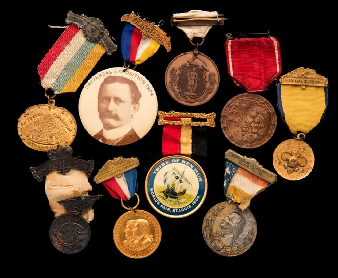 A collection of nine badges for the 1904 Louisiana
