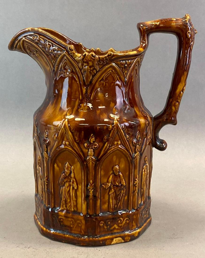 Detailed Catholic Figural Glazed Stoneware Pitcher Auction