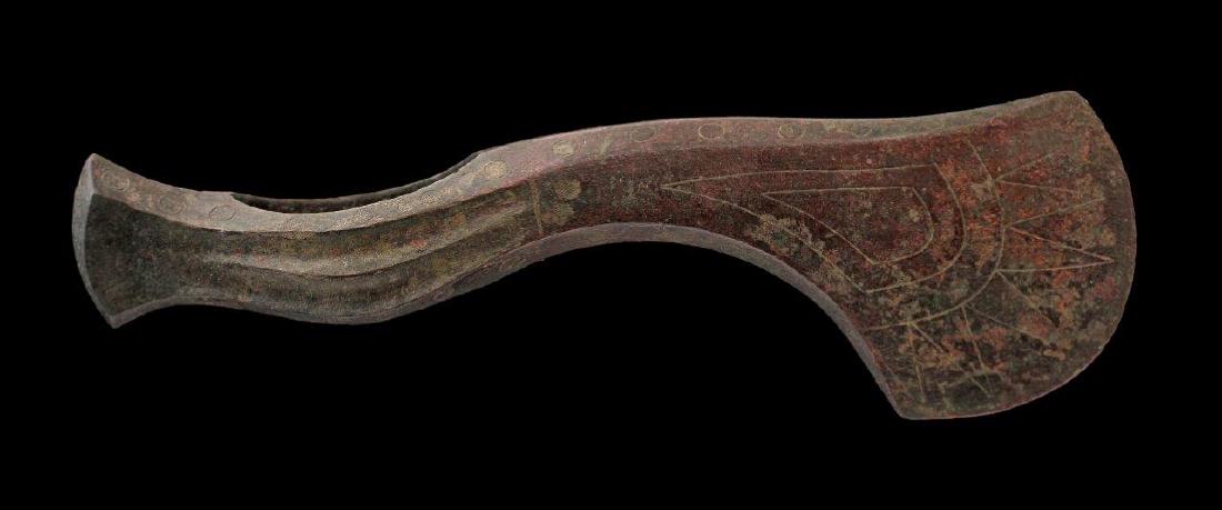 A BRONZE DECORATED AXE, KOBAN CULTURE, 8TH-7TH C. BC