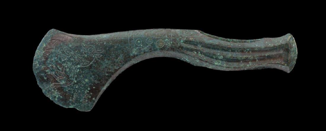A BRONZE DECORATED AXE, KOBAN CULTURE, 8TH-7TH C. BC