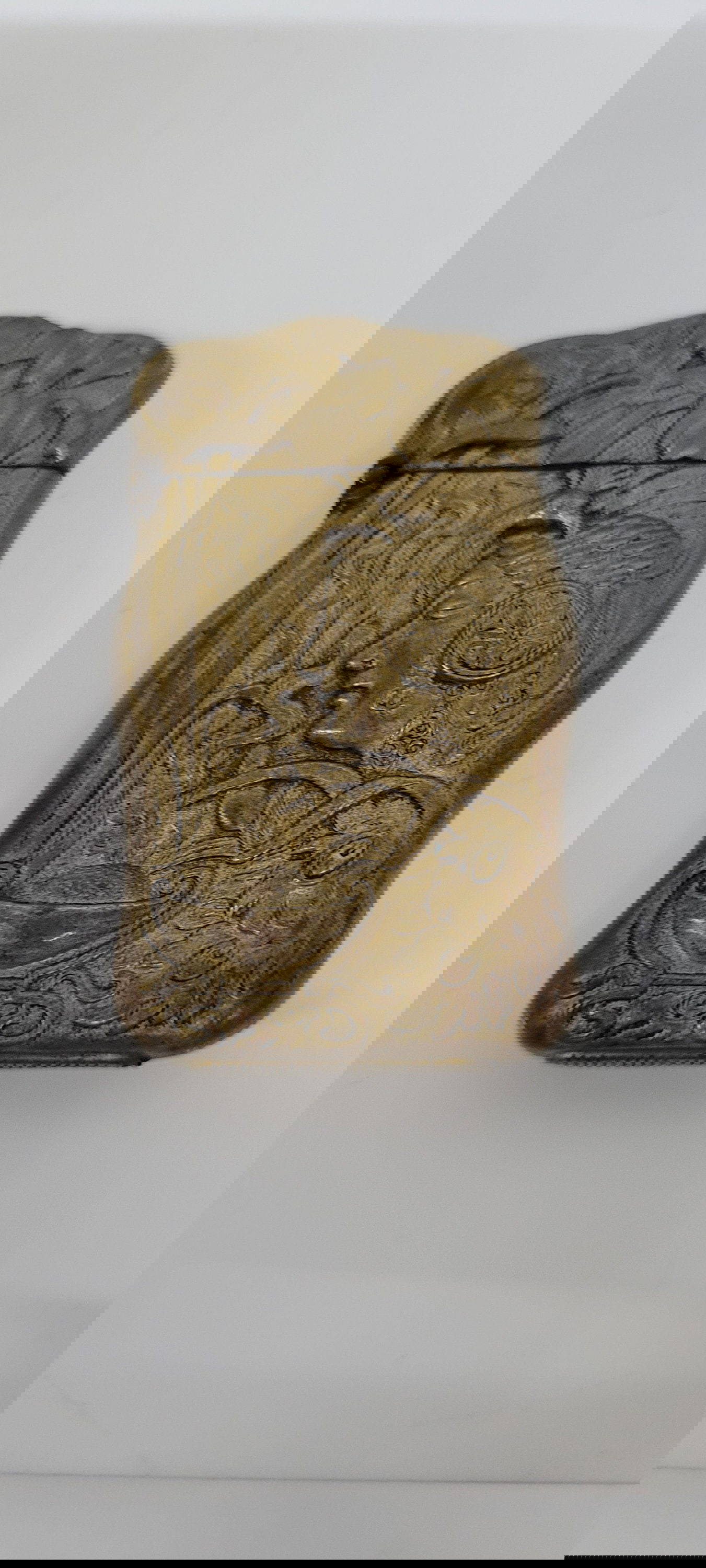 A Gold Metal Matchbox With An Ornate Design Featuring A Woman's Face ...