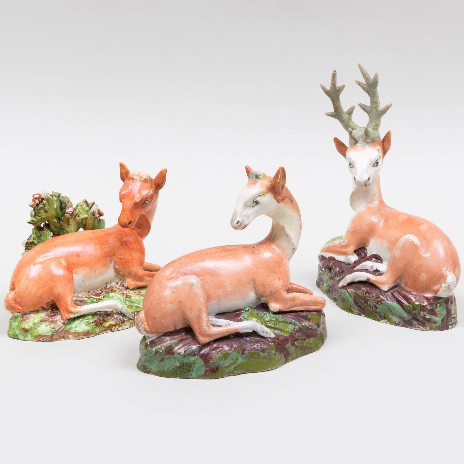 Three Staffordshire Pottery Models Of Recumbent Deer Auction