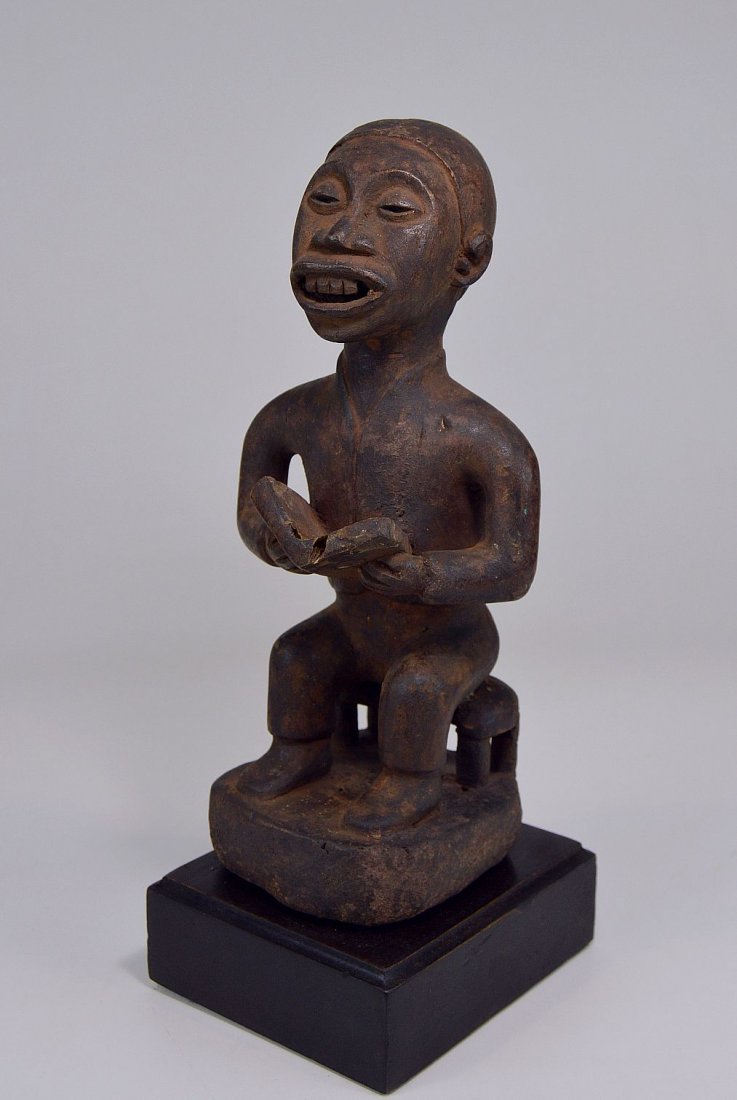 A Fine Kongo Colon Figure Reading the Bible African Art