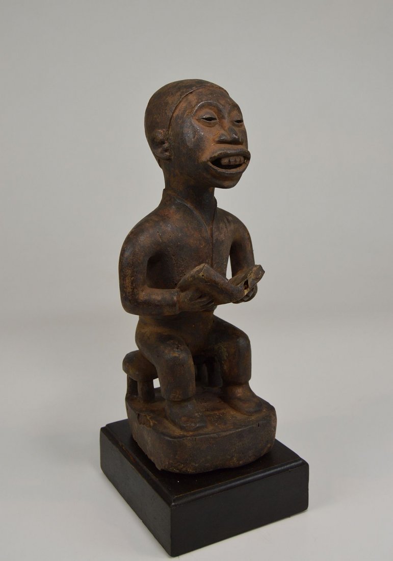 A Fine Kongo Colon Figure Reading the Bible African Art