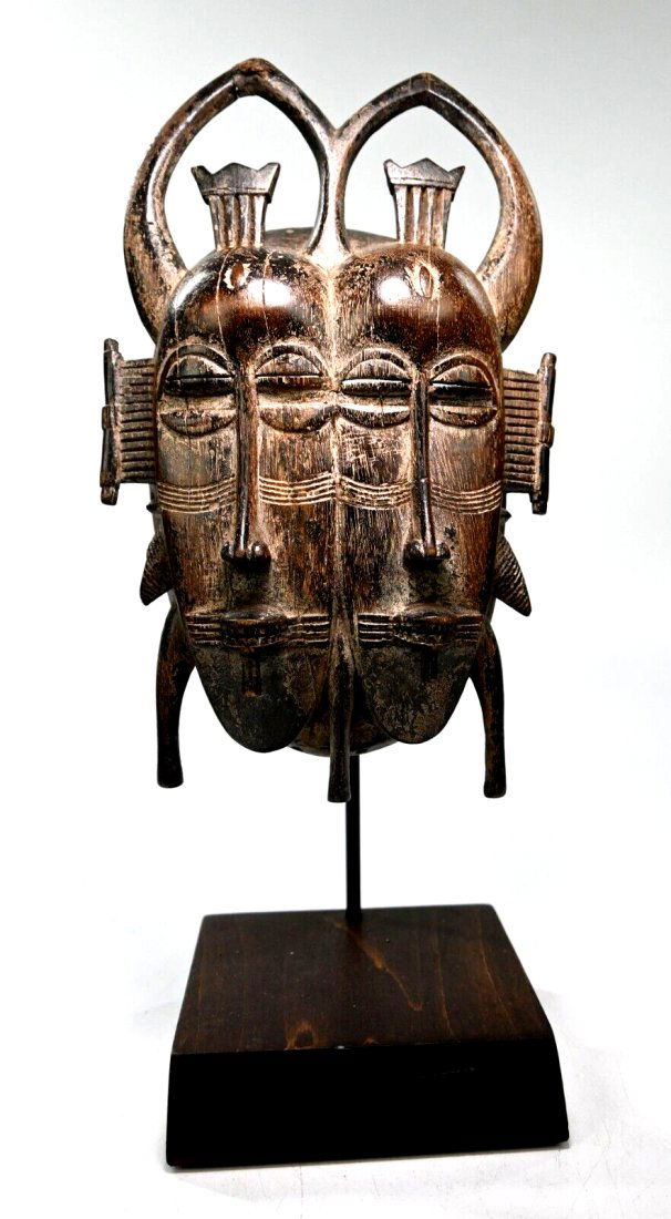 A Senufo Janus Faced Kpelie Mask Auction