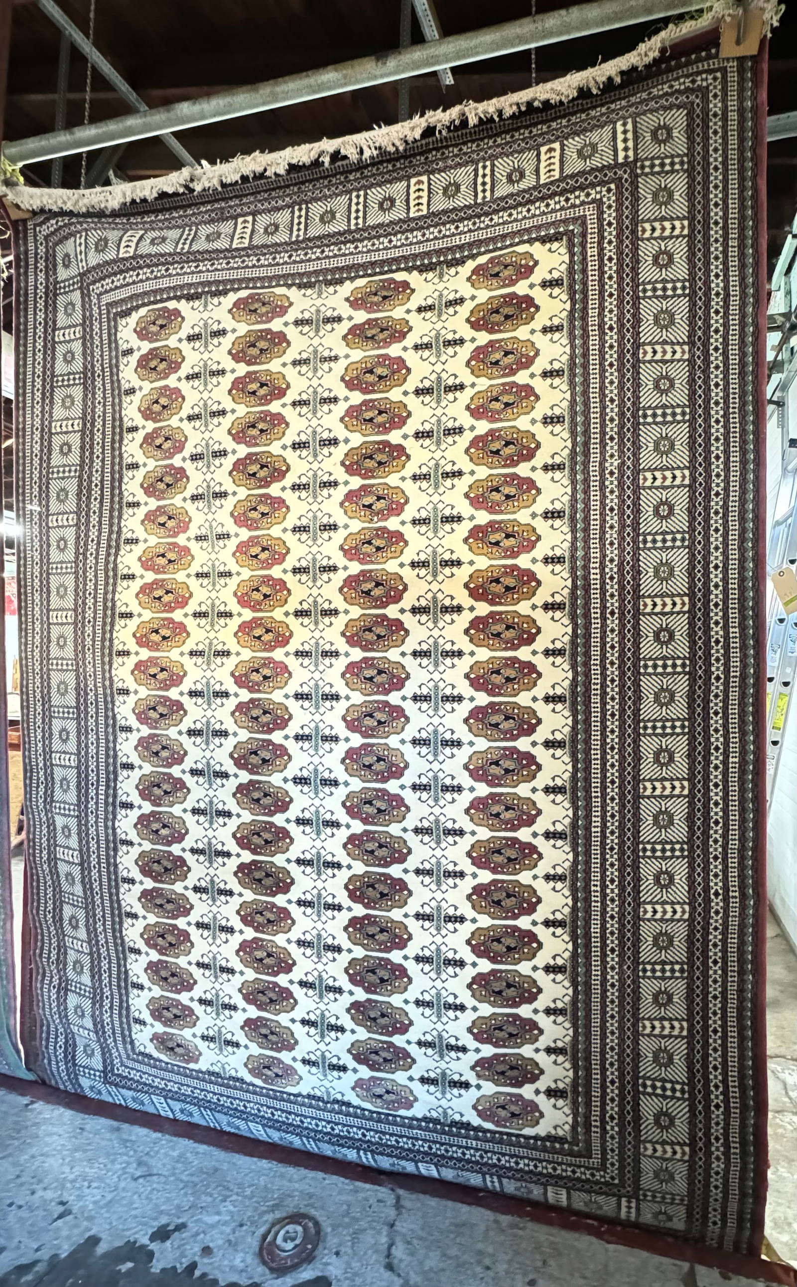 Signed Hali Cream Field Bokhara Pattern Rug. Auction