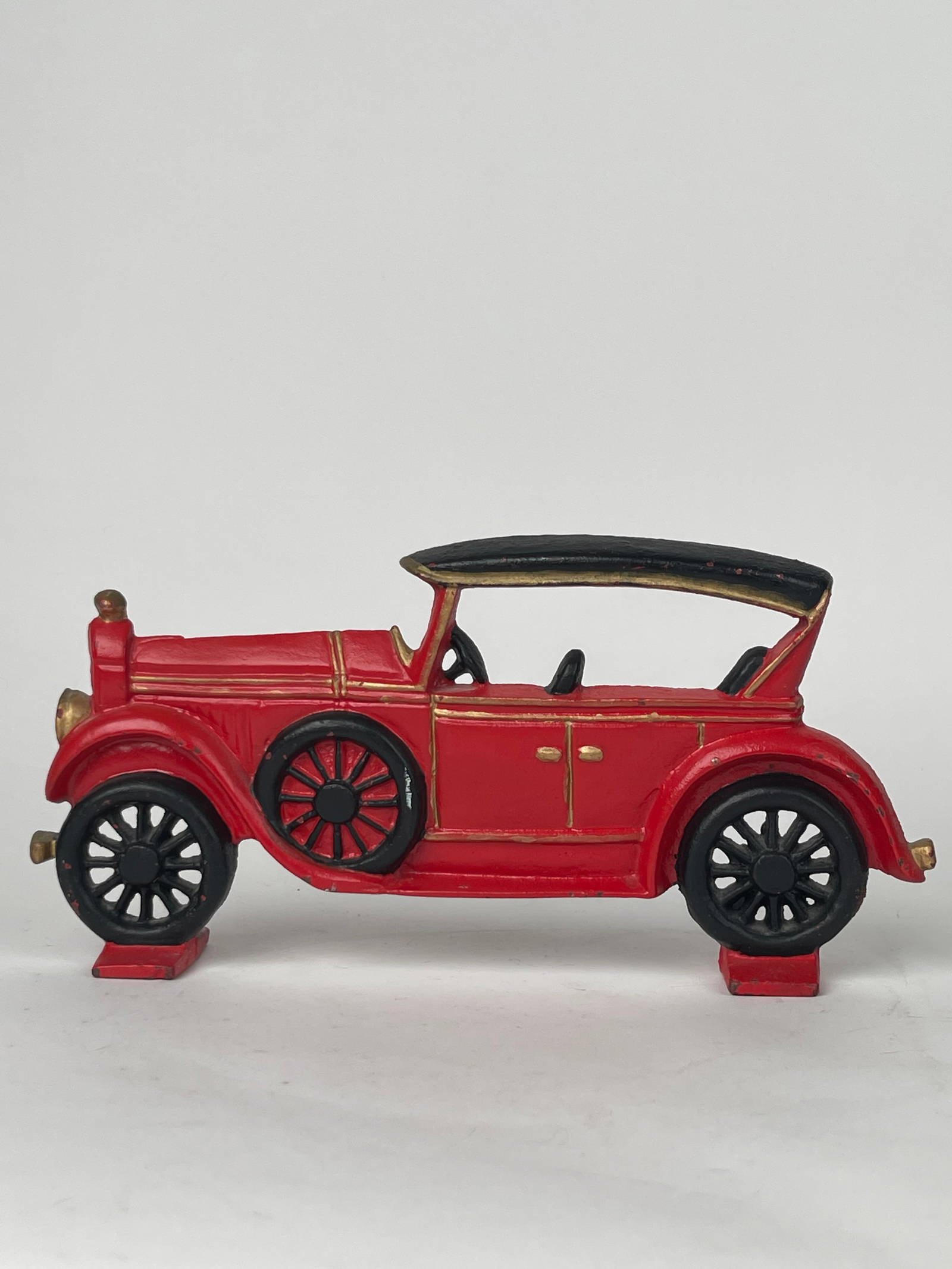 A Cast Iron Door Stop In The Shape Of A Car Auction